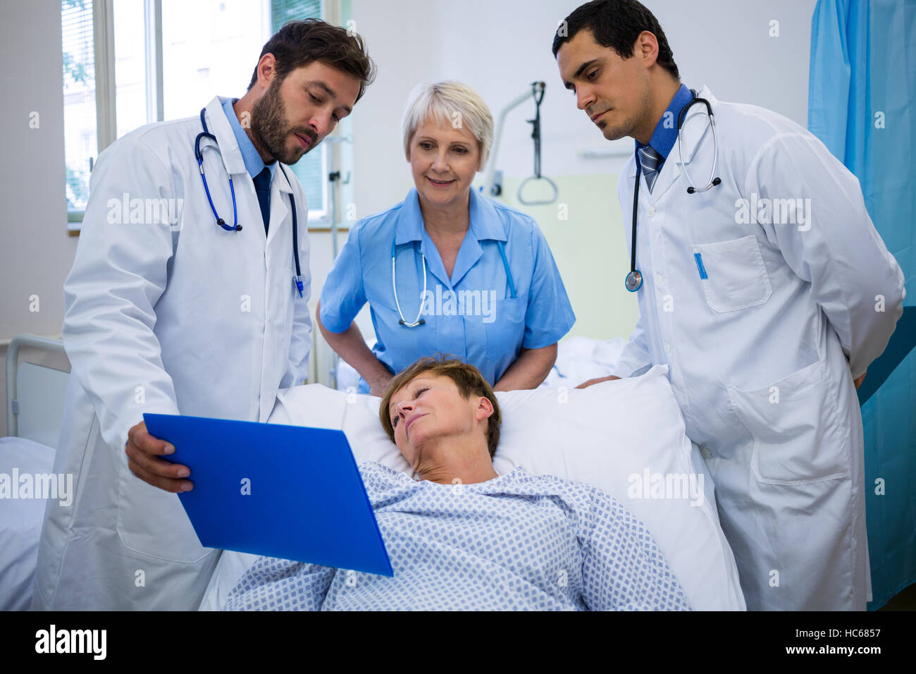Doctors showing medical report to patient Stock Photo - Alamy
