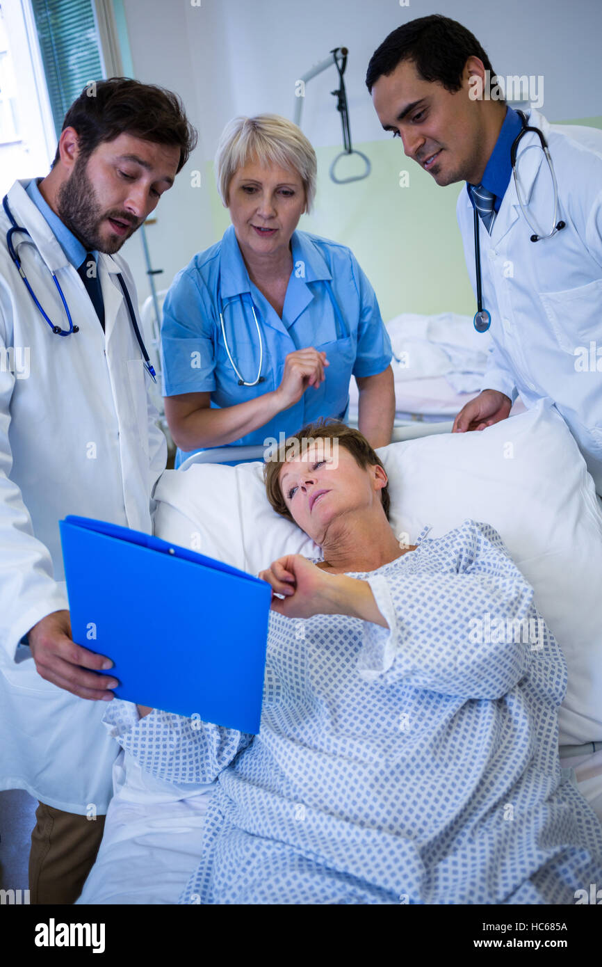 Doctors showing medical report to patient Stock Photo - Alamy