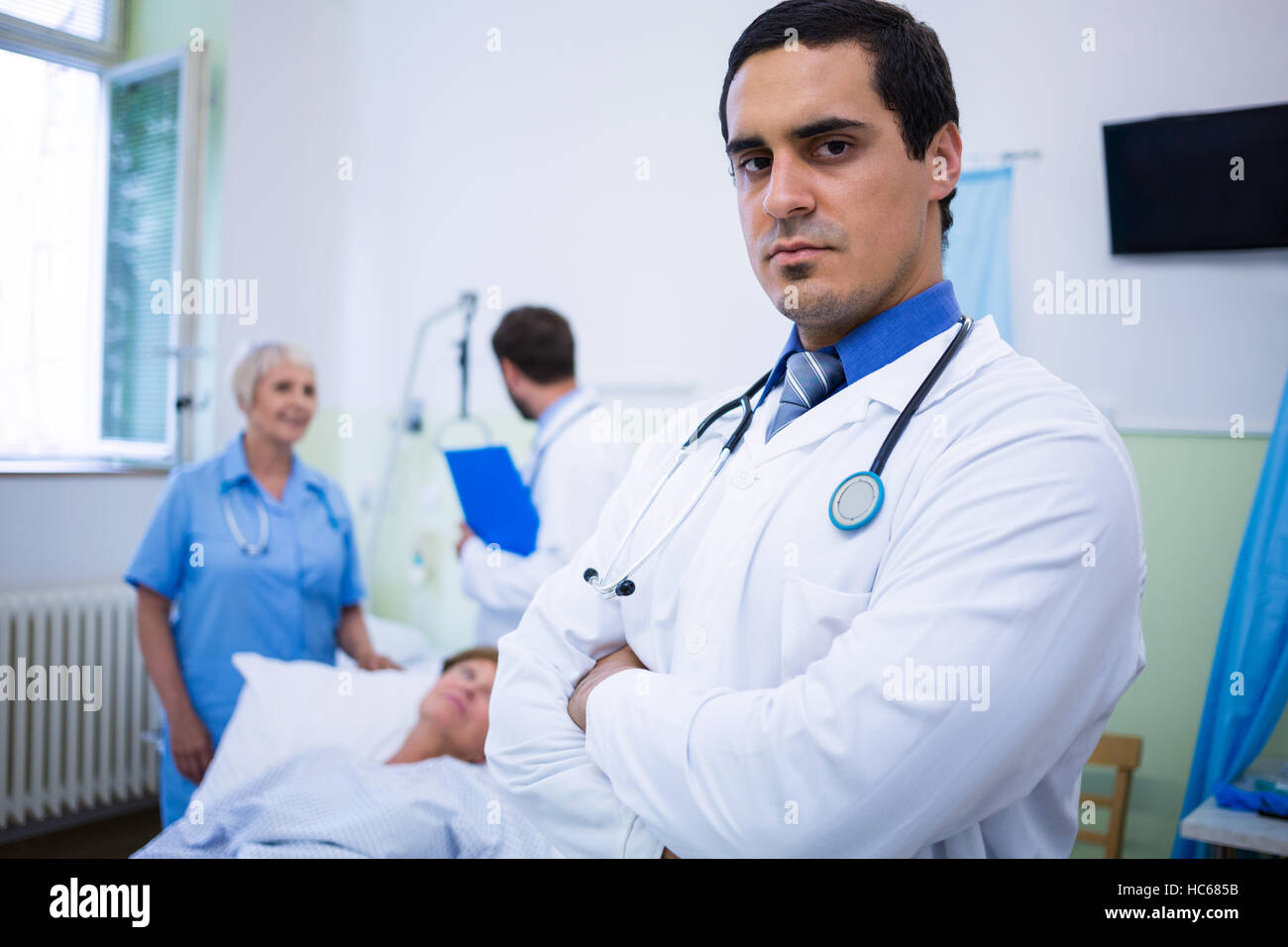 Senior doctor standing hands folded hi-res stock photography and images ...