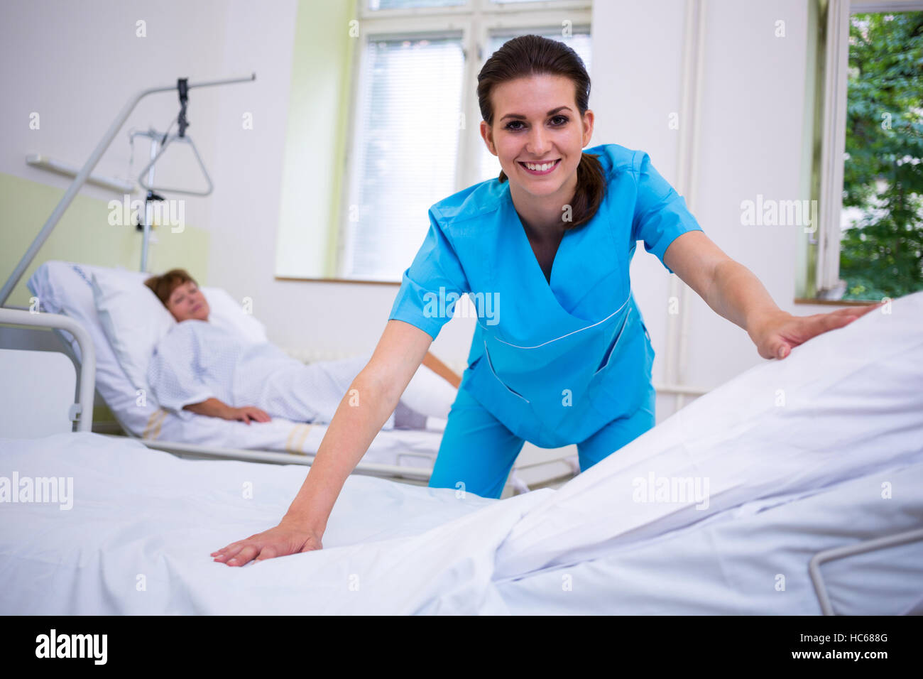 Nurse preparing a bed for a patient Stock Photo - Alamy