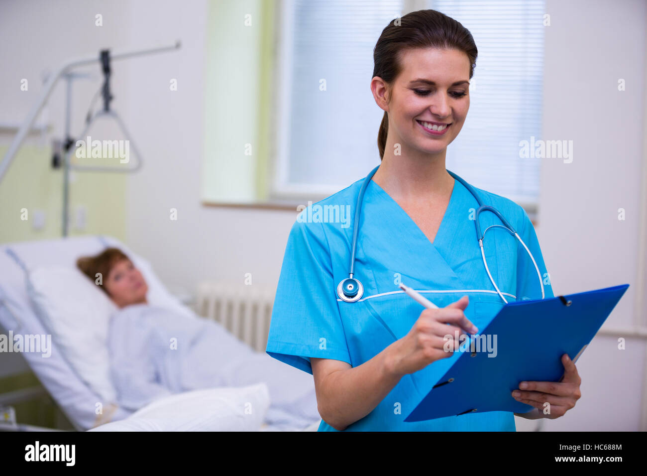 Nurse checking a medical report Stock Photo - Alamy