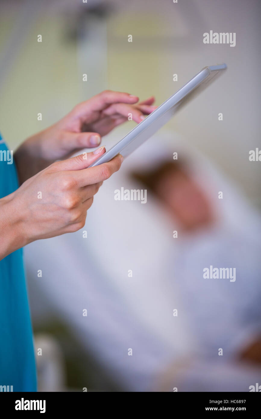 Nurse using digital tablet in hospital ward Stock Photo - Alamy