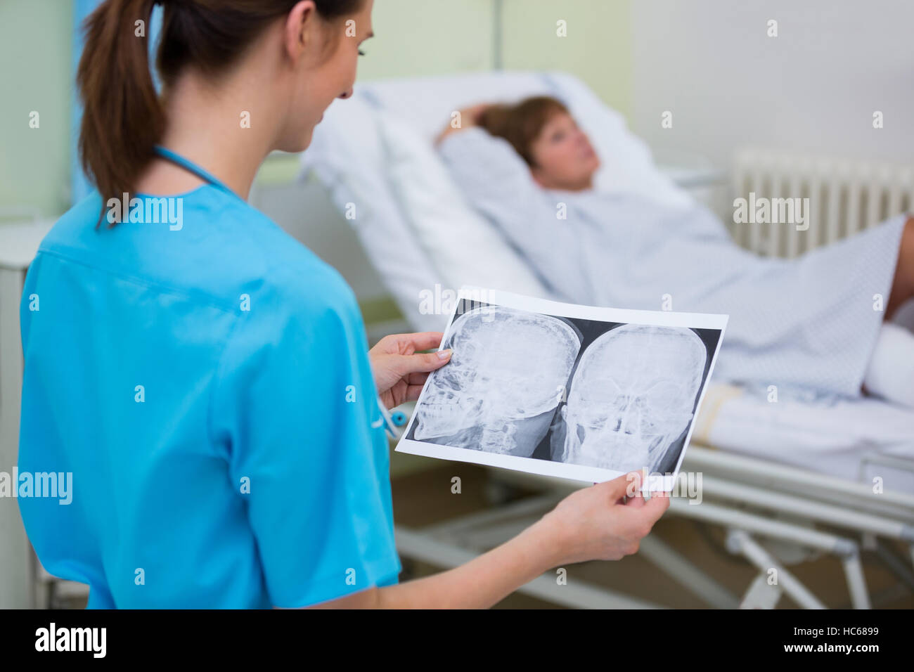 Nurse checking a x-ray in hospital ward Stock Photo - Alamy