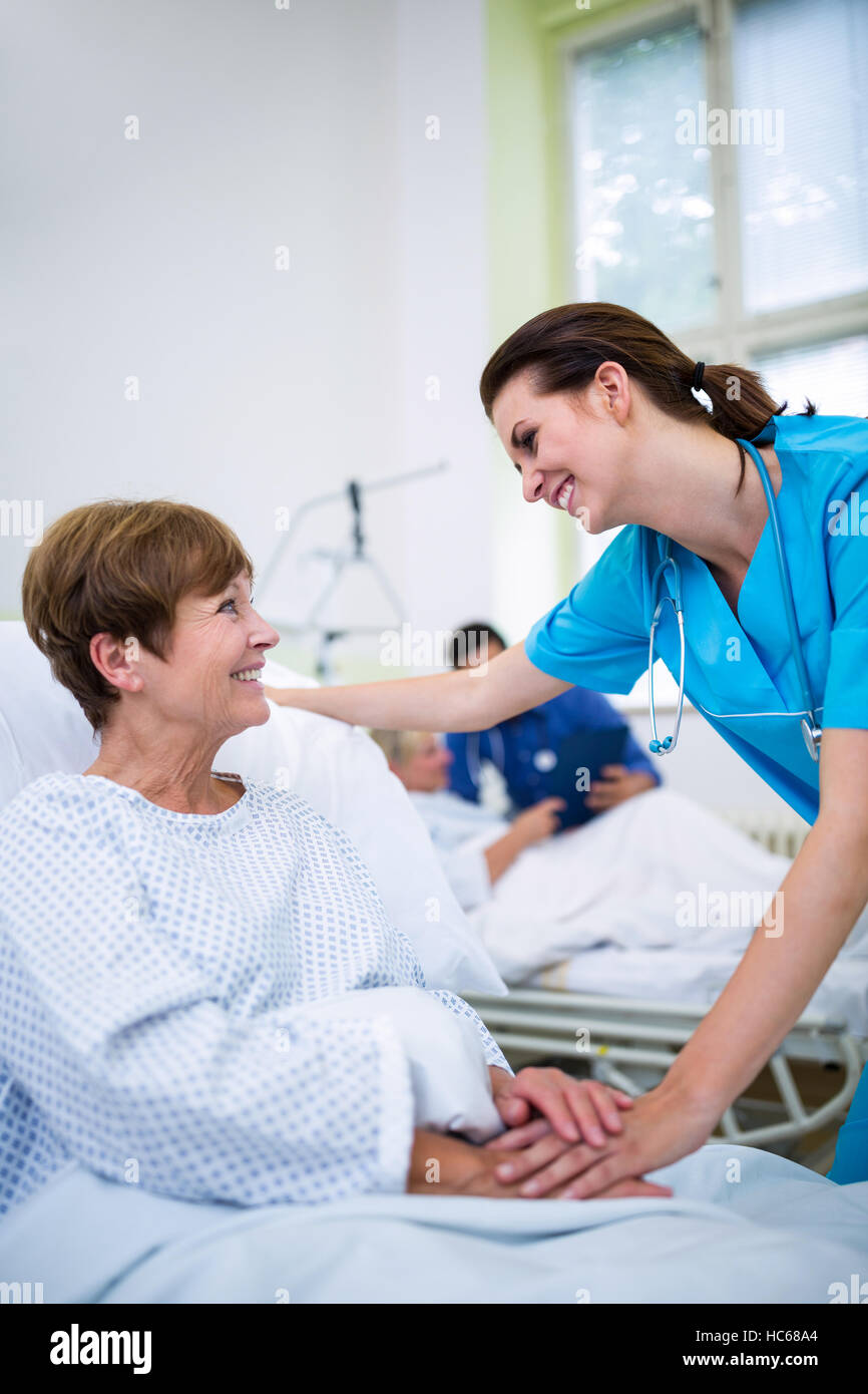 Nurse consoling a patient in hospital ward Stock Photo - Alamy