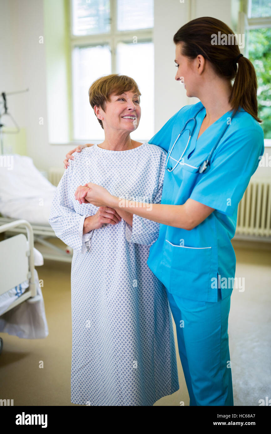Nurse consoling a patient in hospital ward Stock Photo - Alamy