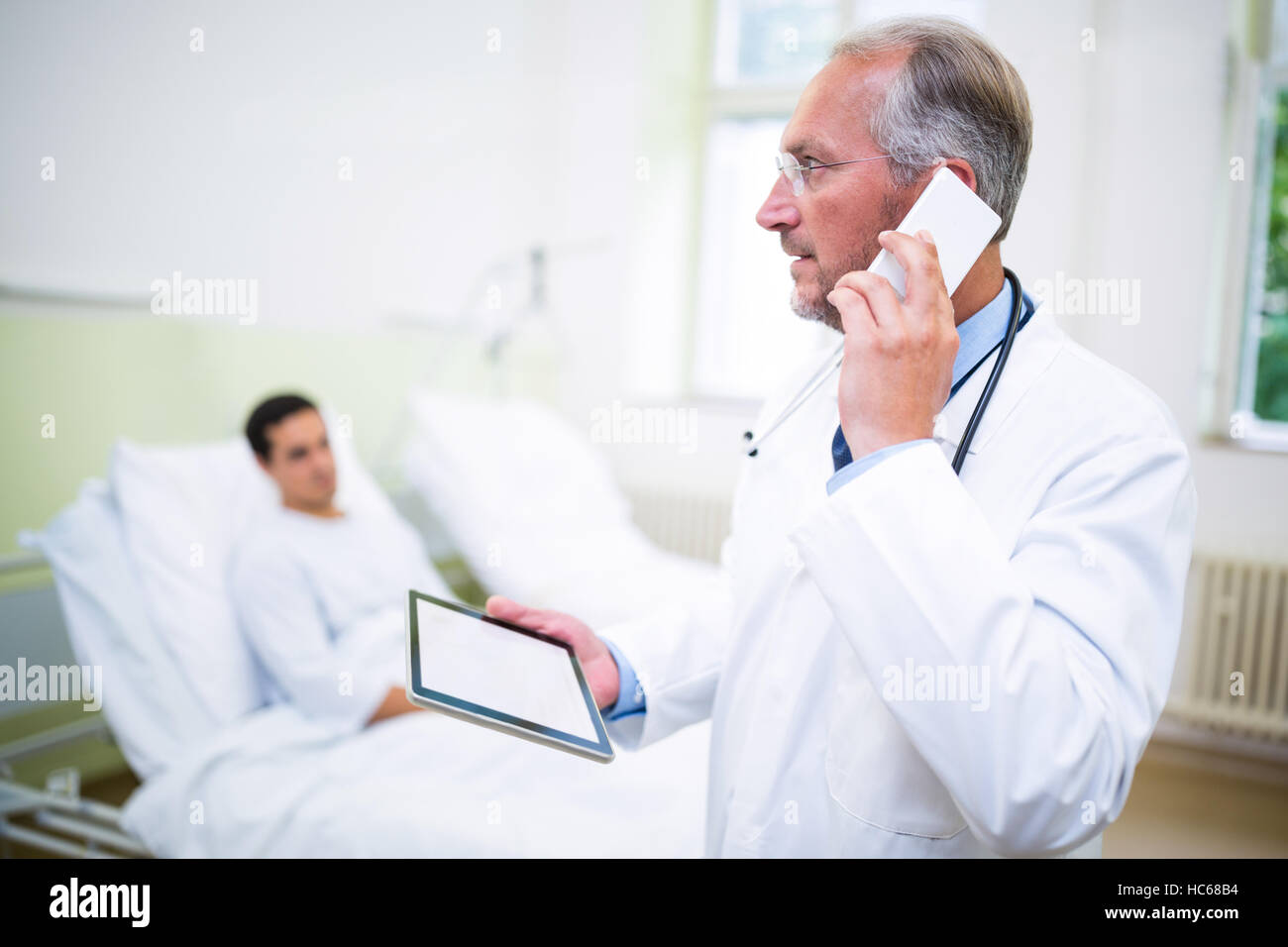 Doctor talking on mobile phone Stock Photo - Alamy
