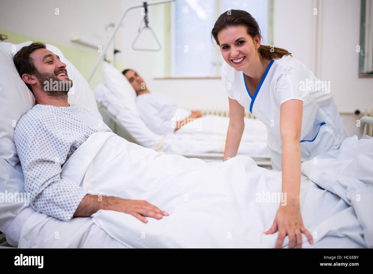Female nurse assisting a patient Stock Photo - Alamy