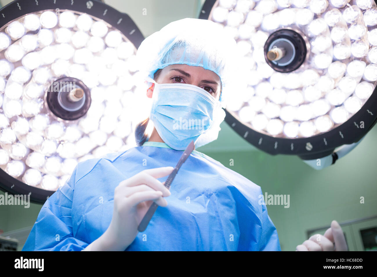 Female surgeon holding medical equipment in operating room Stock Photo ...
