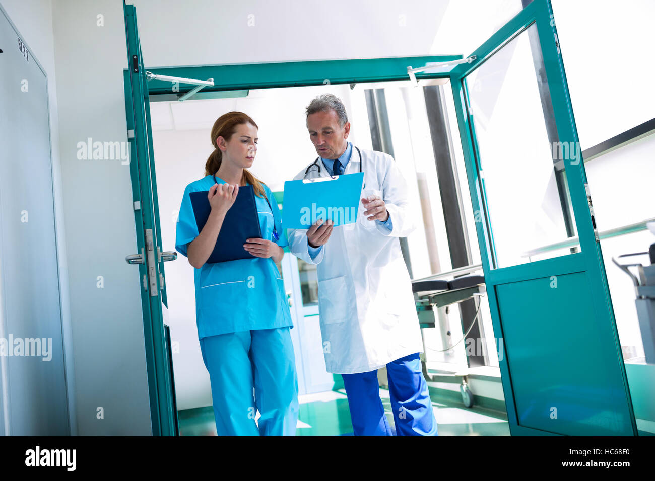 Doctor and nurse checking medical report Stock Photo - Alamy