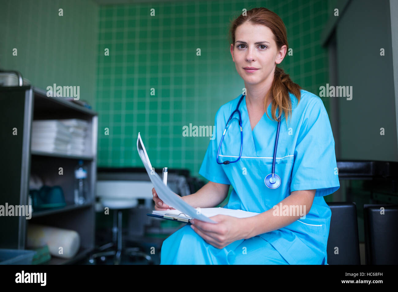 Portrait of nurse holding medical report Stock Photo - Alamy