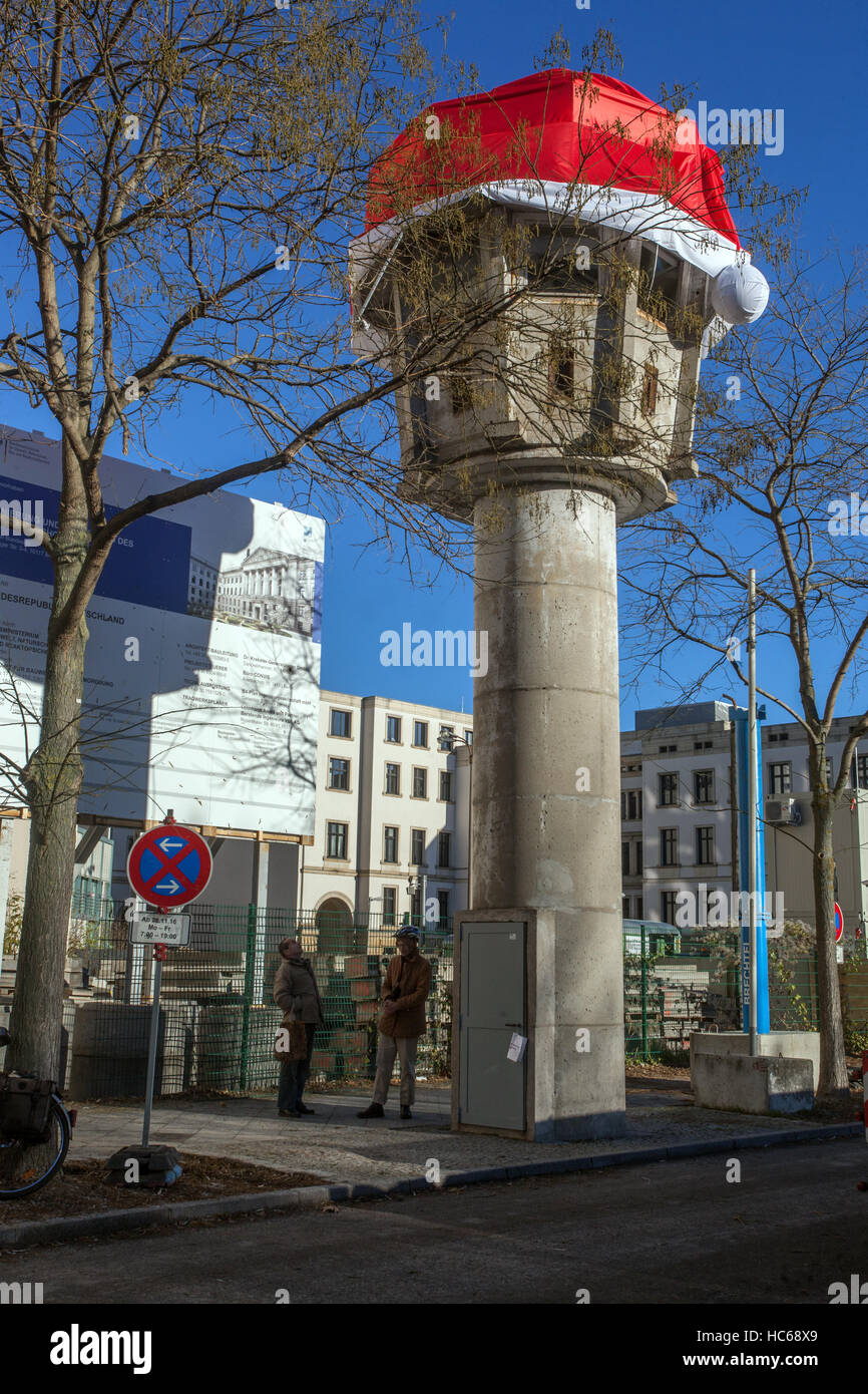 Watchtower, former Berlin Wall construction decorated with a red cap ...