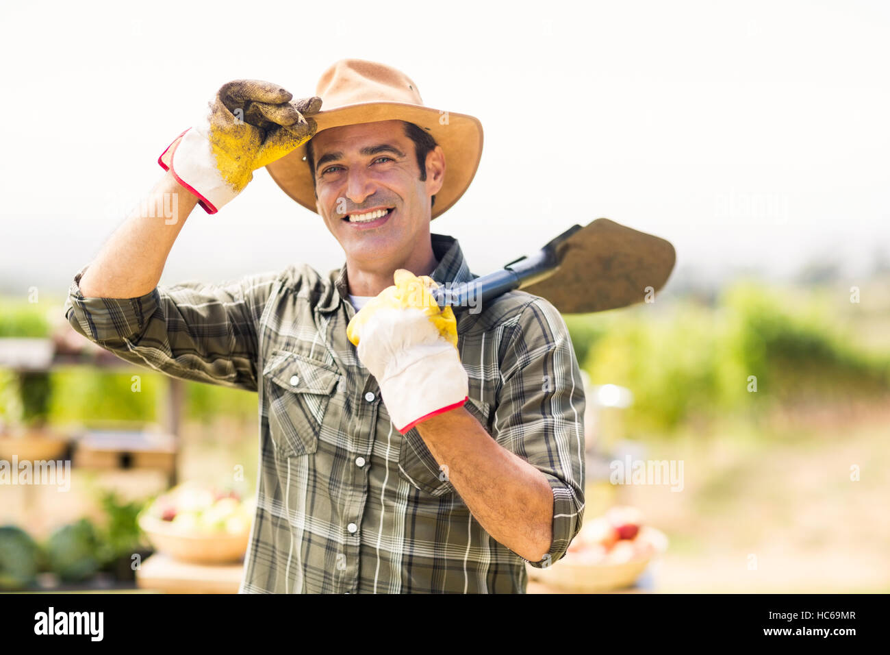 Portrait of farmer carrying shovel Stock Photo - Alamy