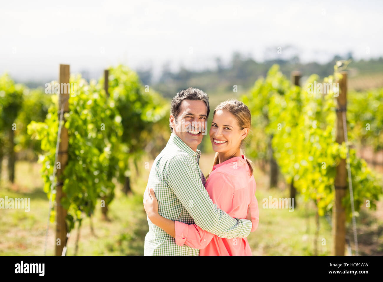 Portrait of happy couple standing with arm around Stock Photo - Alamy