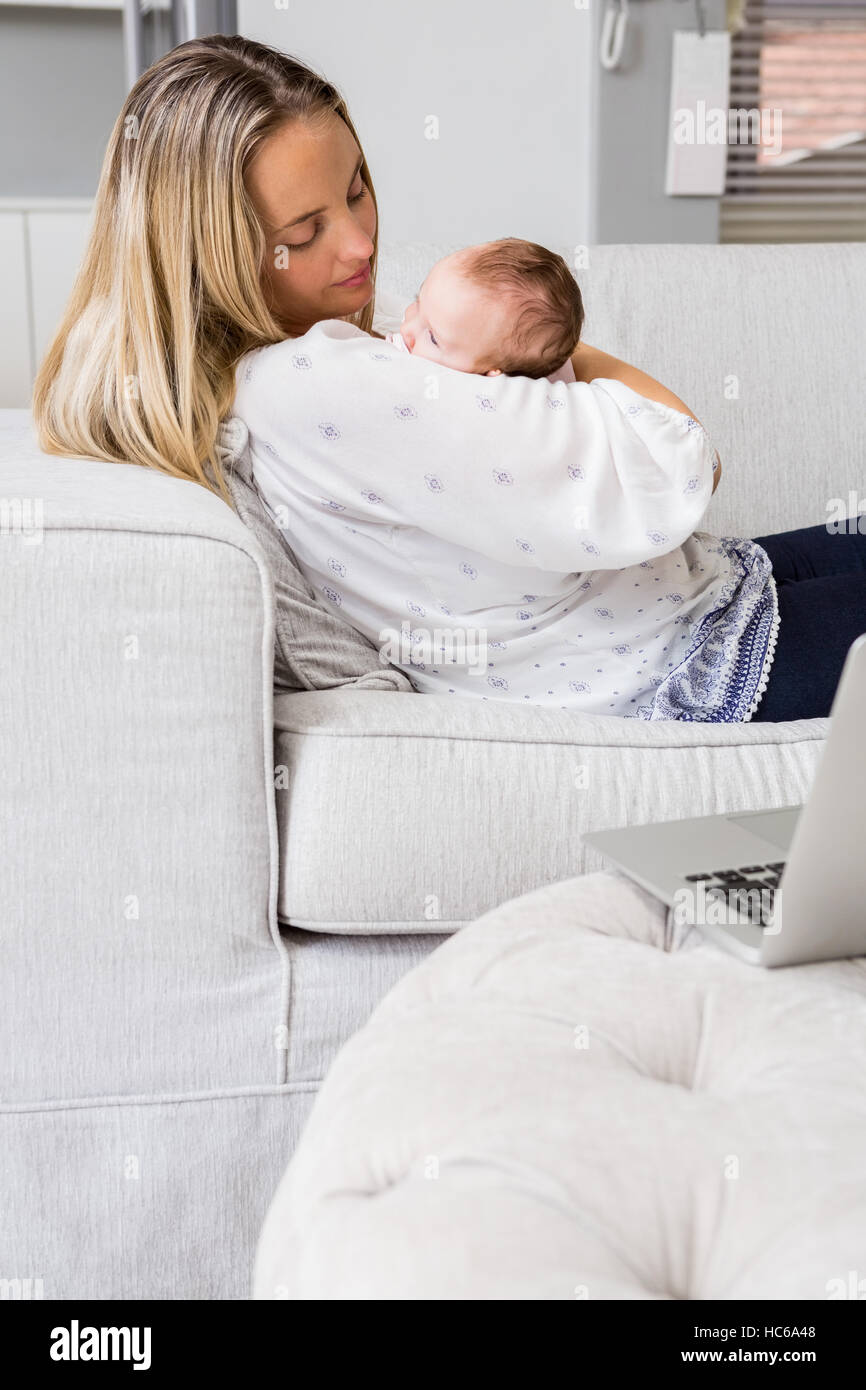 Mother carrying her baby in living room Stock Photo - Alamy