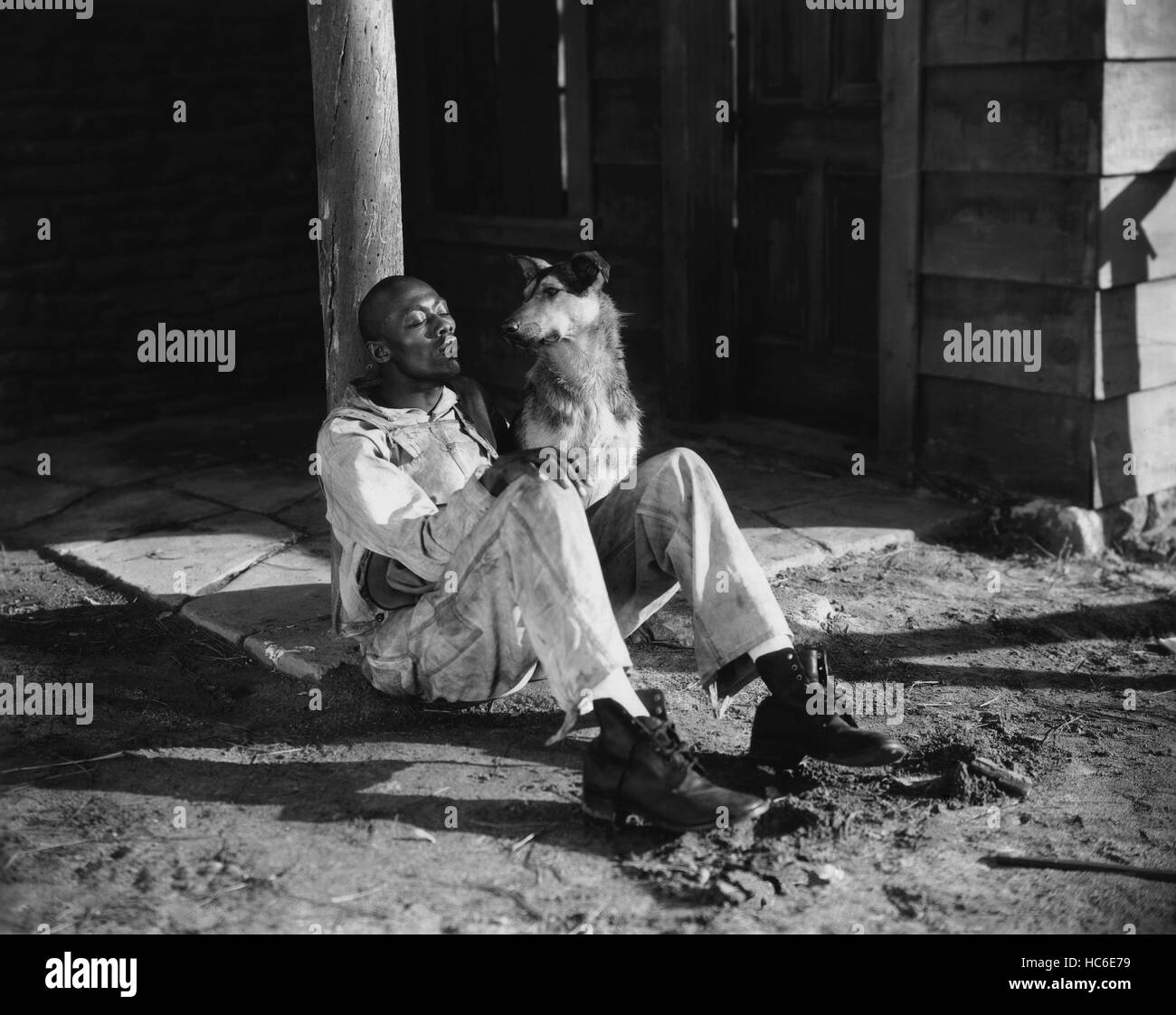 STAND UP AND CHEER!, Stepin Fetchit, relaxing with a dog between takes ...