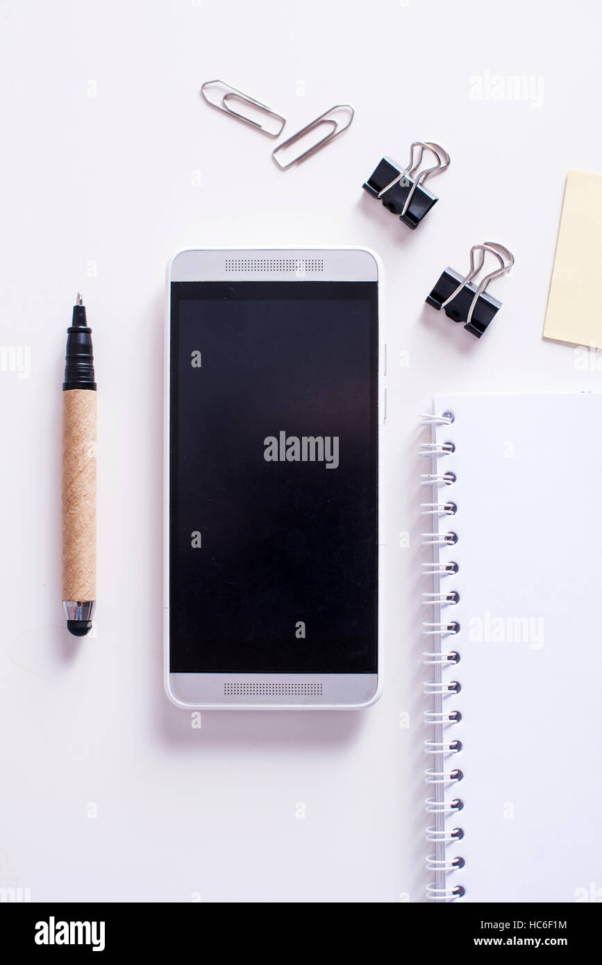 Mobile phone and note book. Office concept Stock Photo - Alamy