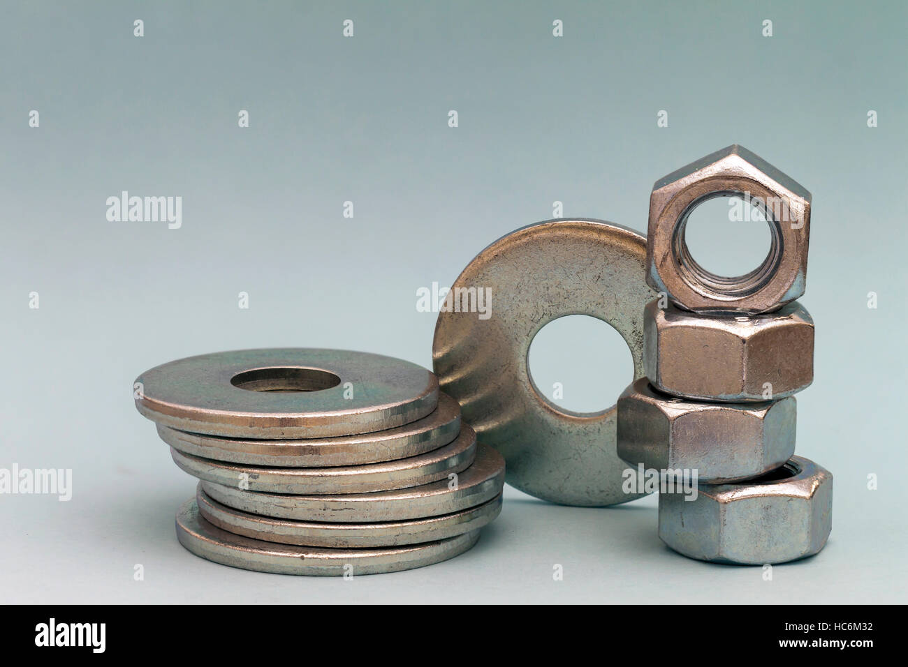 Joiner's accessories. Stacks of metal screw washers and nuts isolated ...