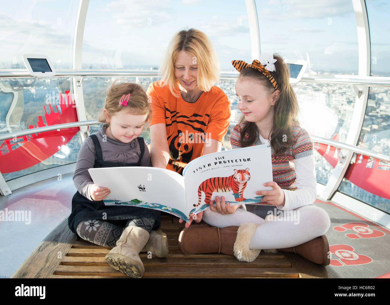 (L-R) Elsie Cutts, Becci May and Ruby Cutts read The Tiger Protector ...