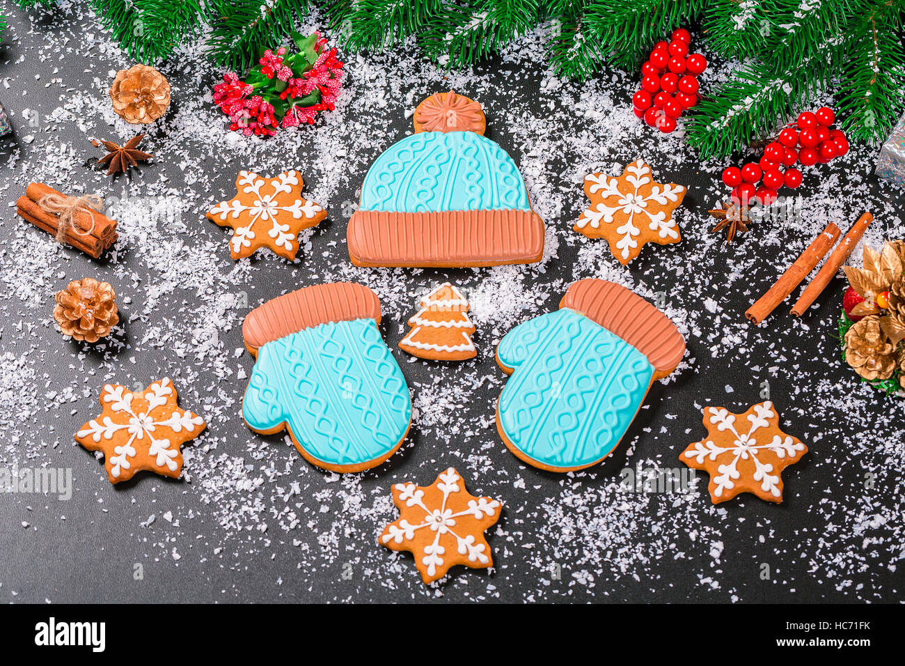 Beautiful Christmas gingerbread hat and gloves in the snow, tree ...