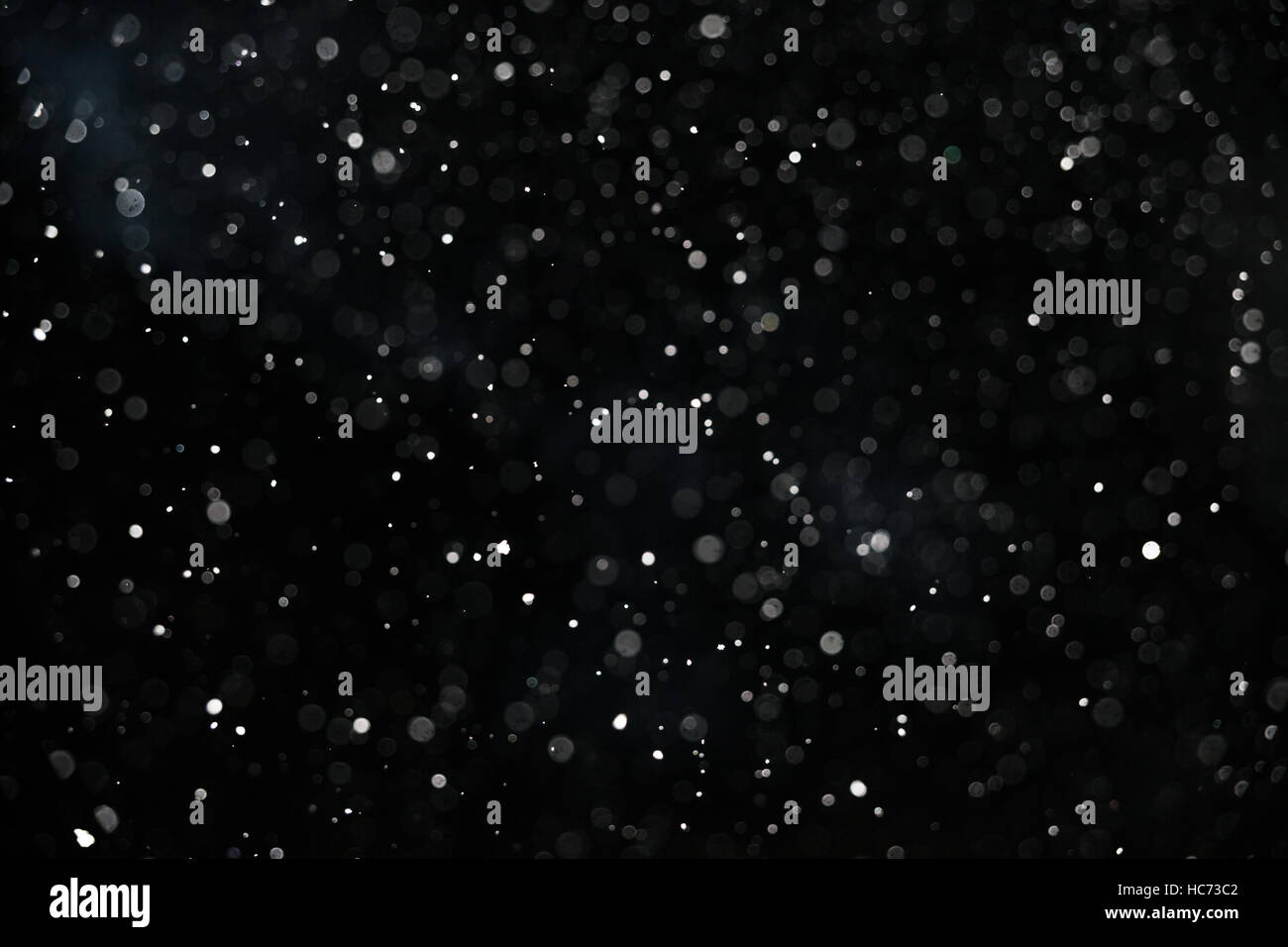 Falling snow on black background Stock Photo - Alamy
