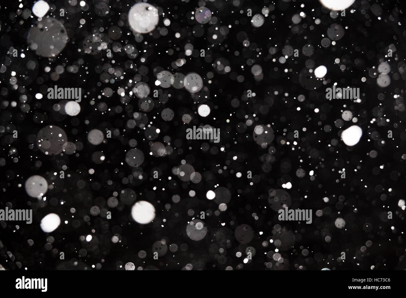 Falling snow on black background Stock Photo - Alamy