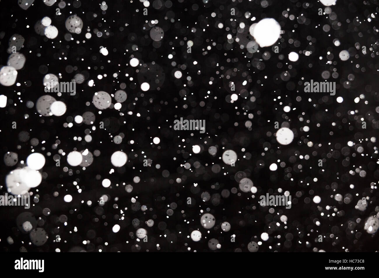 Falling snow on black background Stock Photo - Alamy