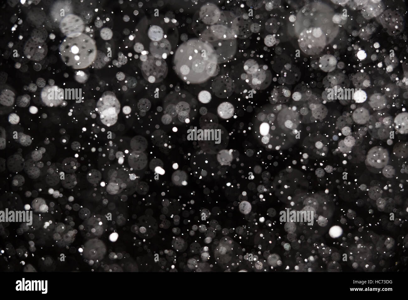 Falling snow on black background Stock Photo - Alamy