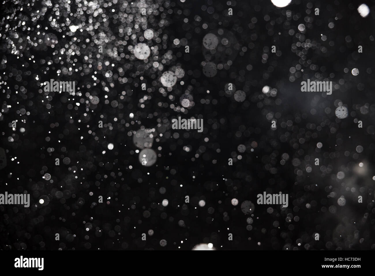 Falling snow on black background Stock Photo - Alamy