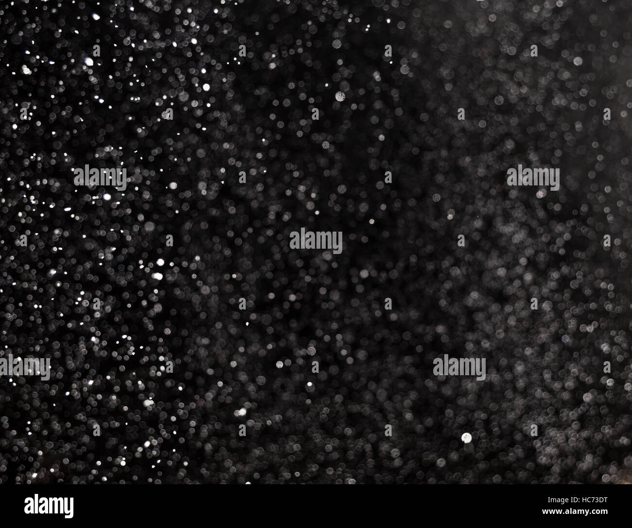 Falling snow on black background Stock Photo - Alamy