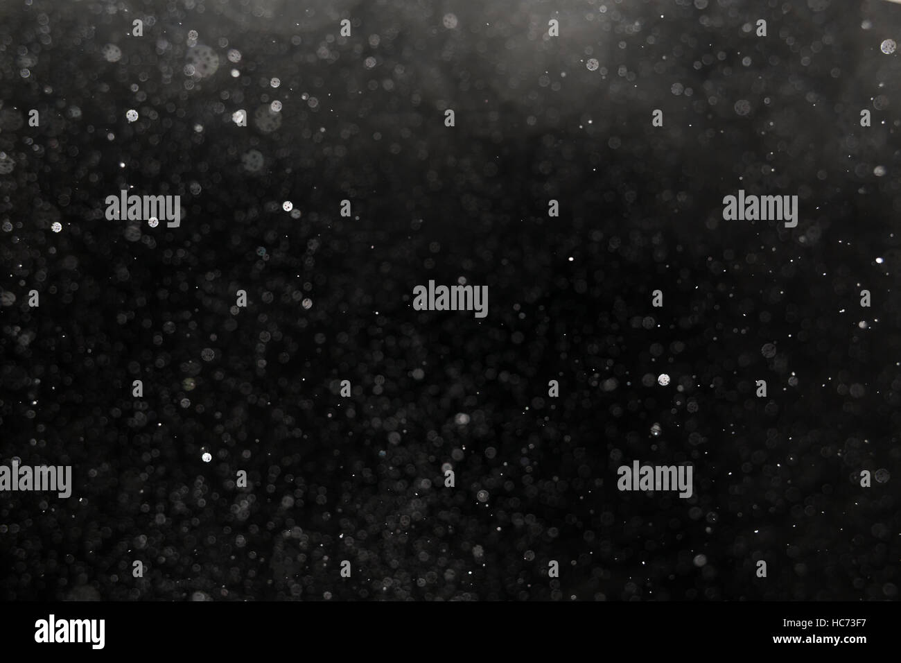 Falling snow on black background Stock Photo - Alamy
