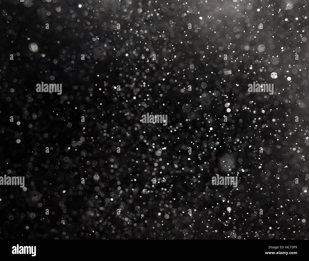 Falling snow on black background Stock Photo - Alamy