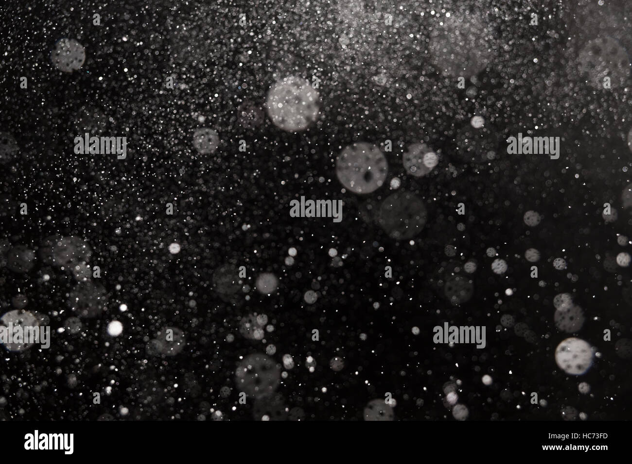 Falling snow on black background Stock Photo - Alamy