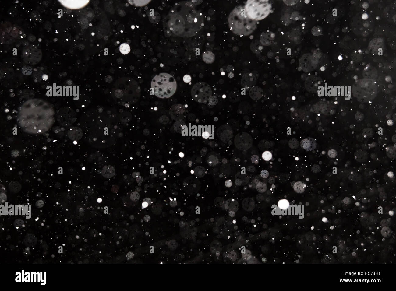Falling snow on black background Stock Photo - Alamy