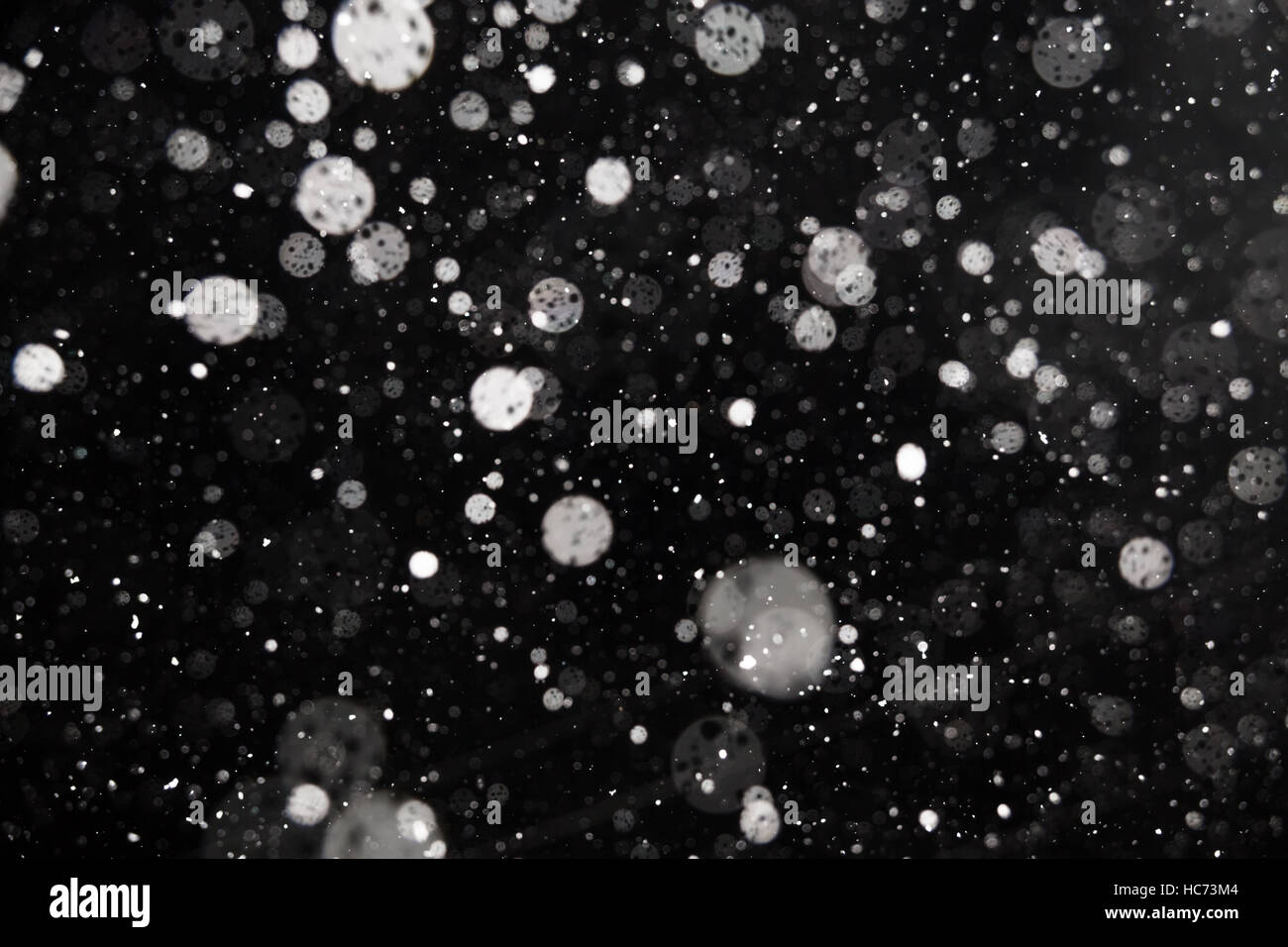 Falling snow on black background Stock Photo - Alamy