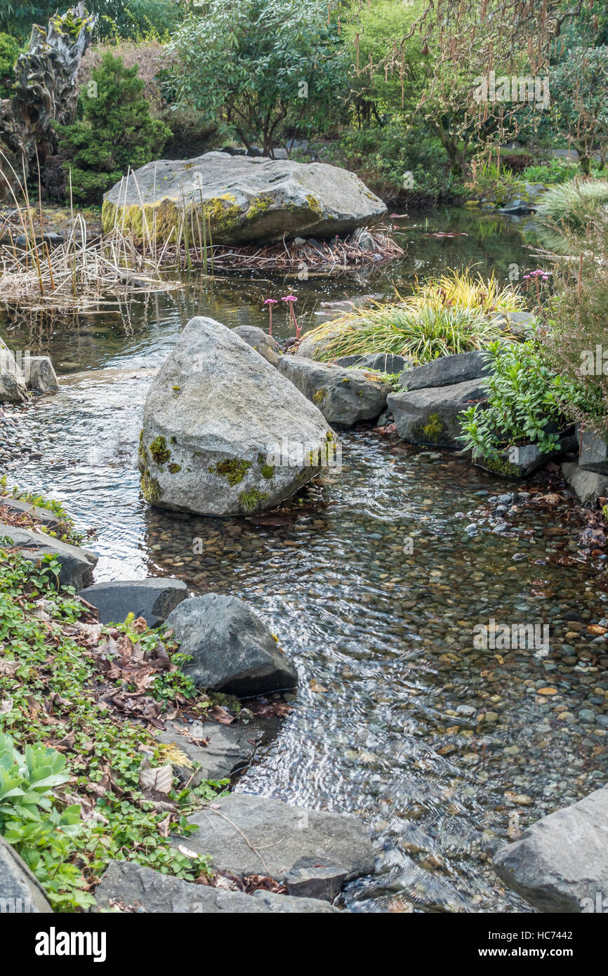 A stream flows around large boulders in Seatac, Washington Stock Photo ...