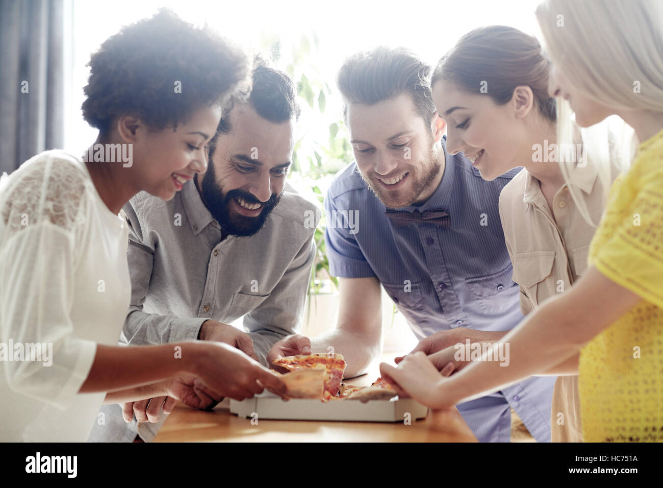 happy business team eating pizza in office Stock Photo - Alamy