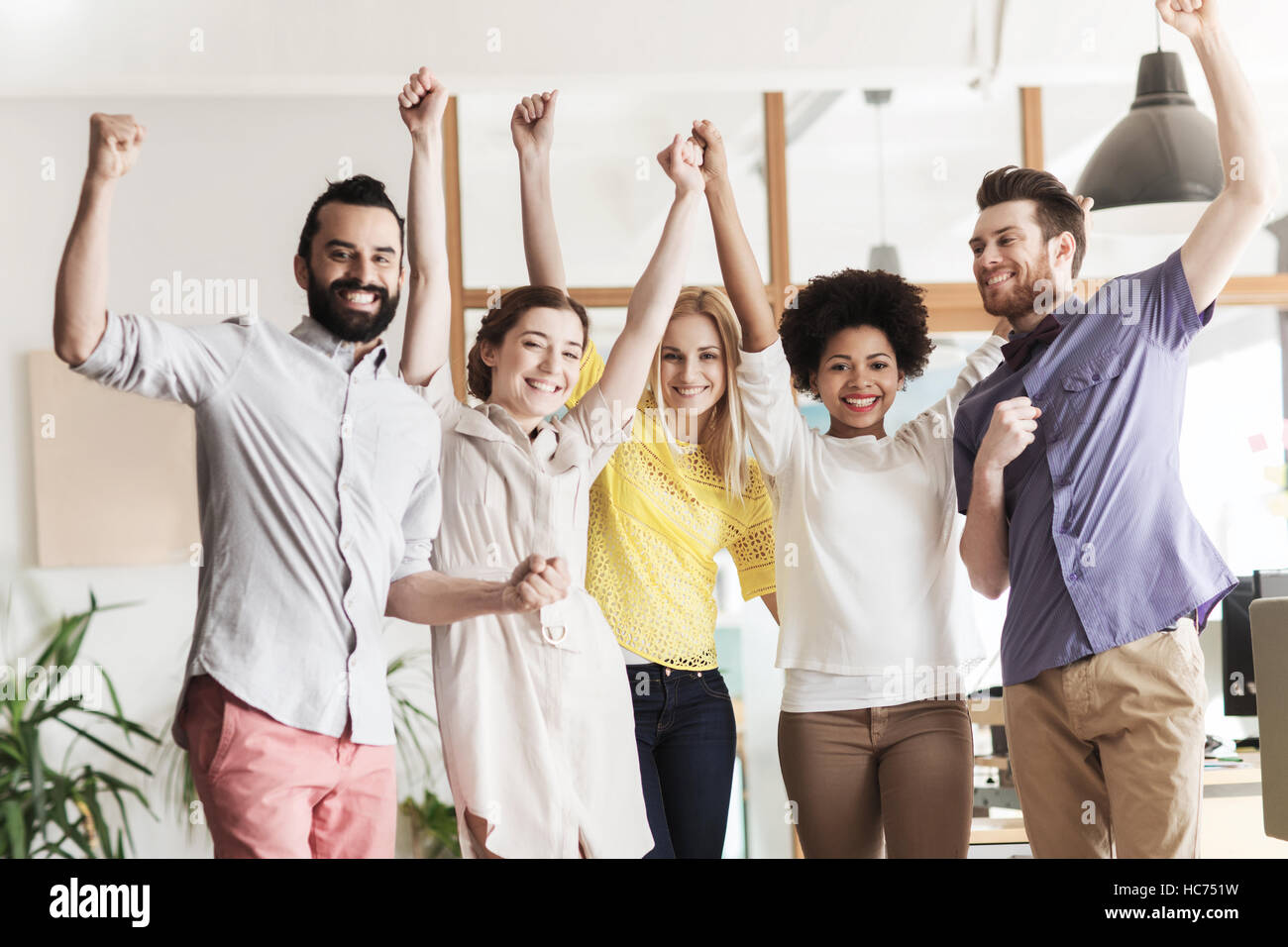 happy creative team celebrating victory in office Stock Photo - Alamy