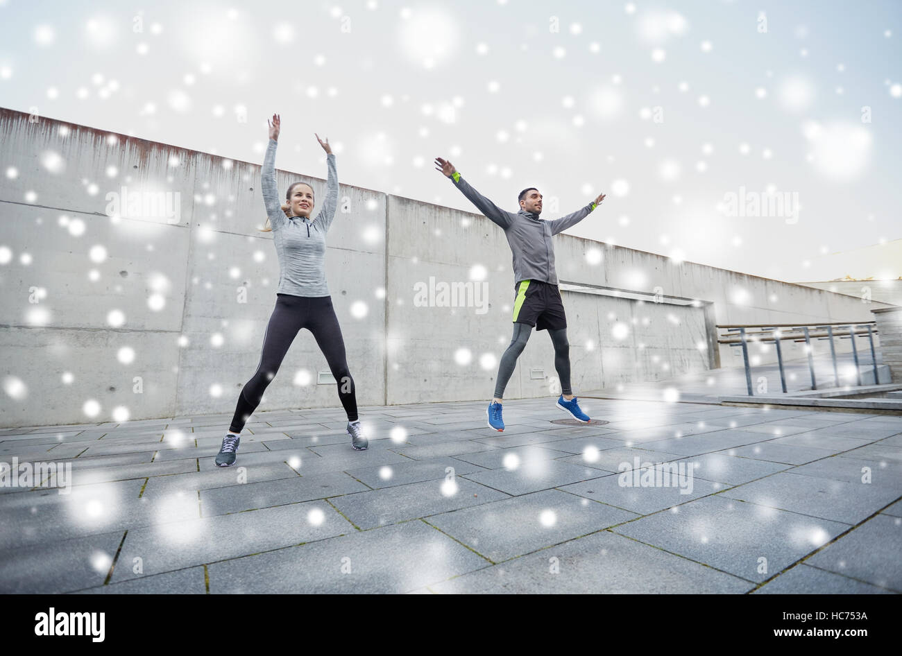 happy man and woman jumping outdoors Stock Photo - Alamy