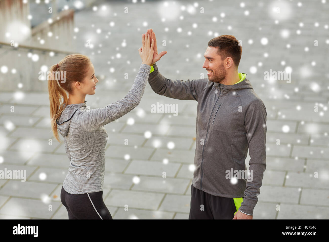 happy couple giving high five outdoors Stock Photo - Alamy