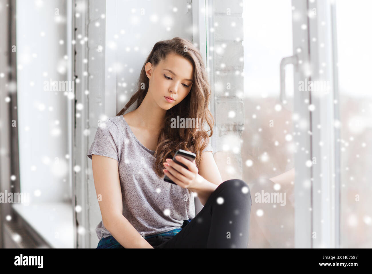 sad pretty teenage girl with smartphone texting Stock Photo - Alamy