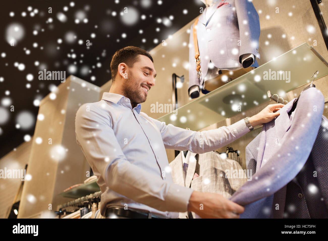happy young man choosing clothes in clothing store Stock Photo - Alamy