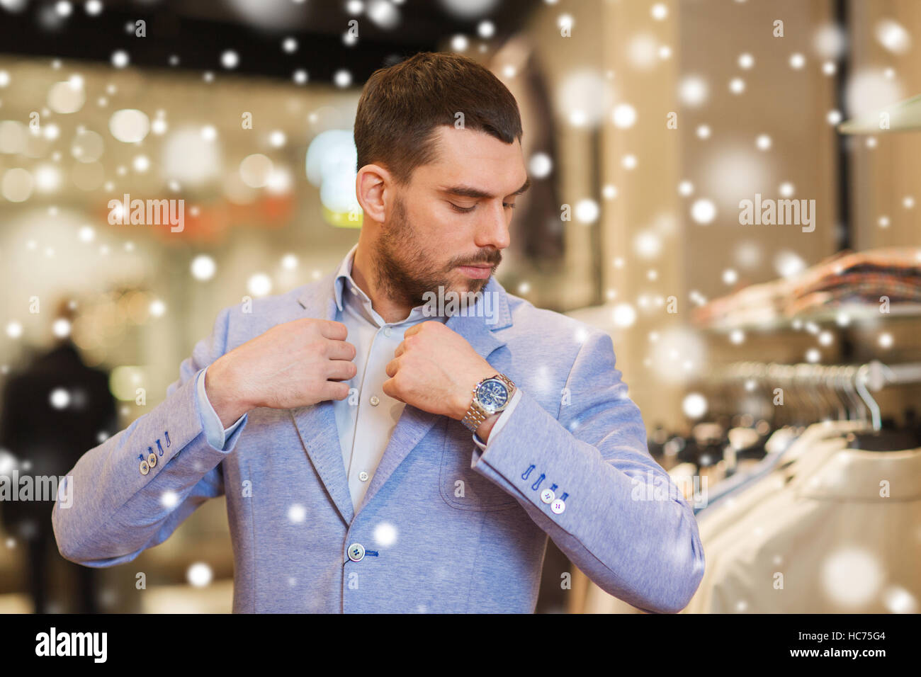 Young man putting on jacket hi-res stock photography and images - Alamy