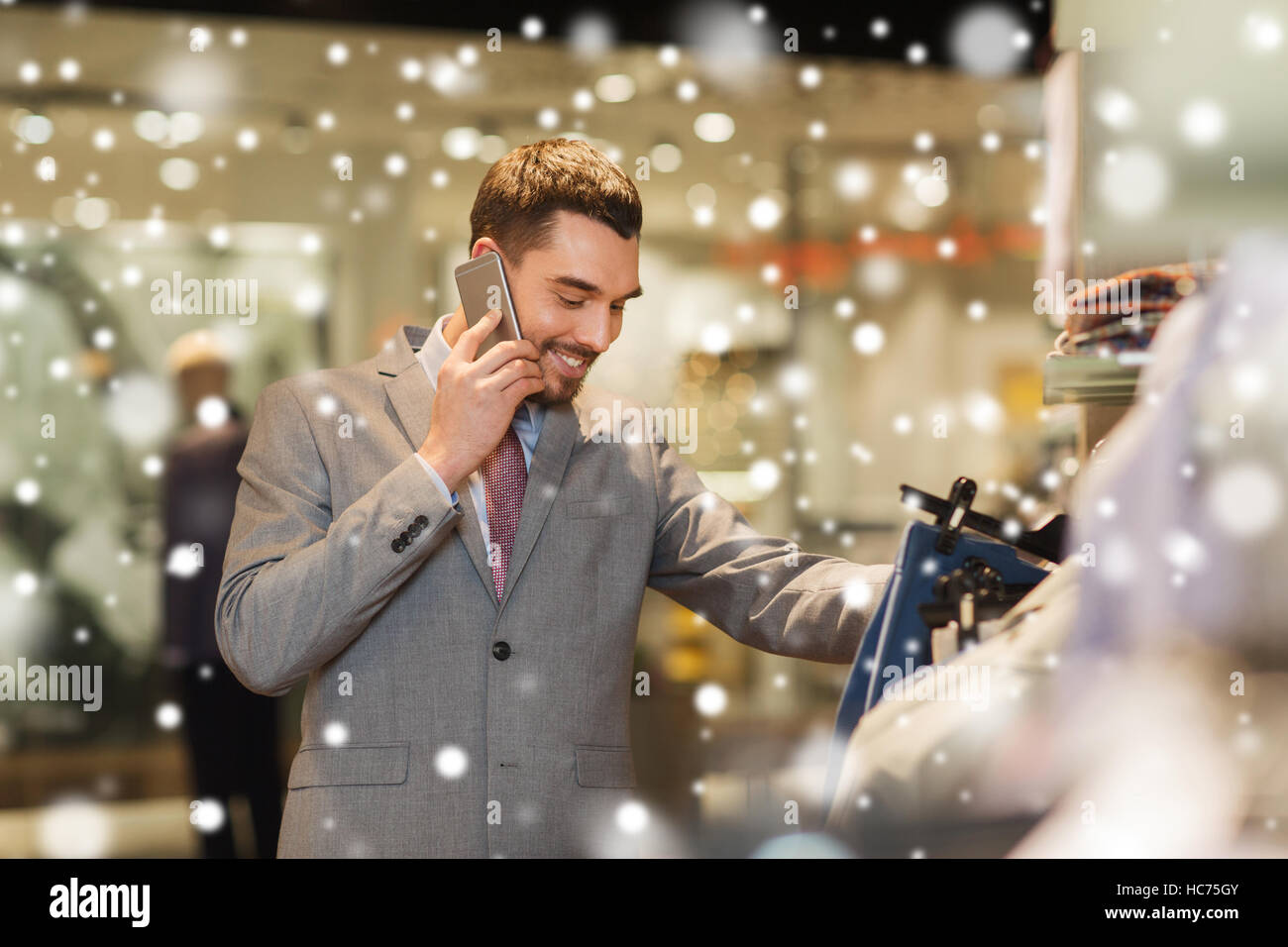 happy man calling on smartphone at clothing store Stock Photo - Alamy