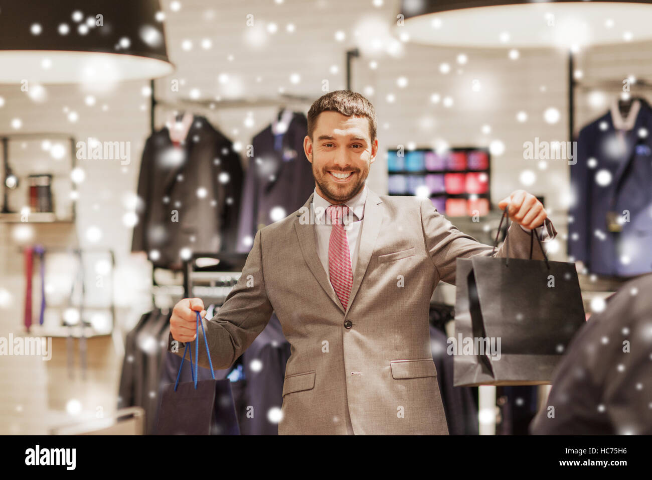 happy man with shopping bags at clothing store Stock Photo - Alamy