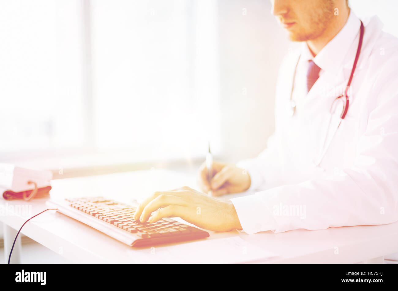 male doctor typing on the keyboard Stock Photo - Alamy