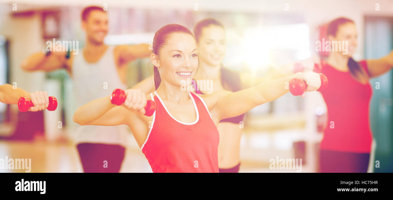 group of smiling people working out with dumbbells Stock Photo - Alamy