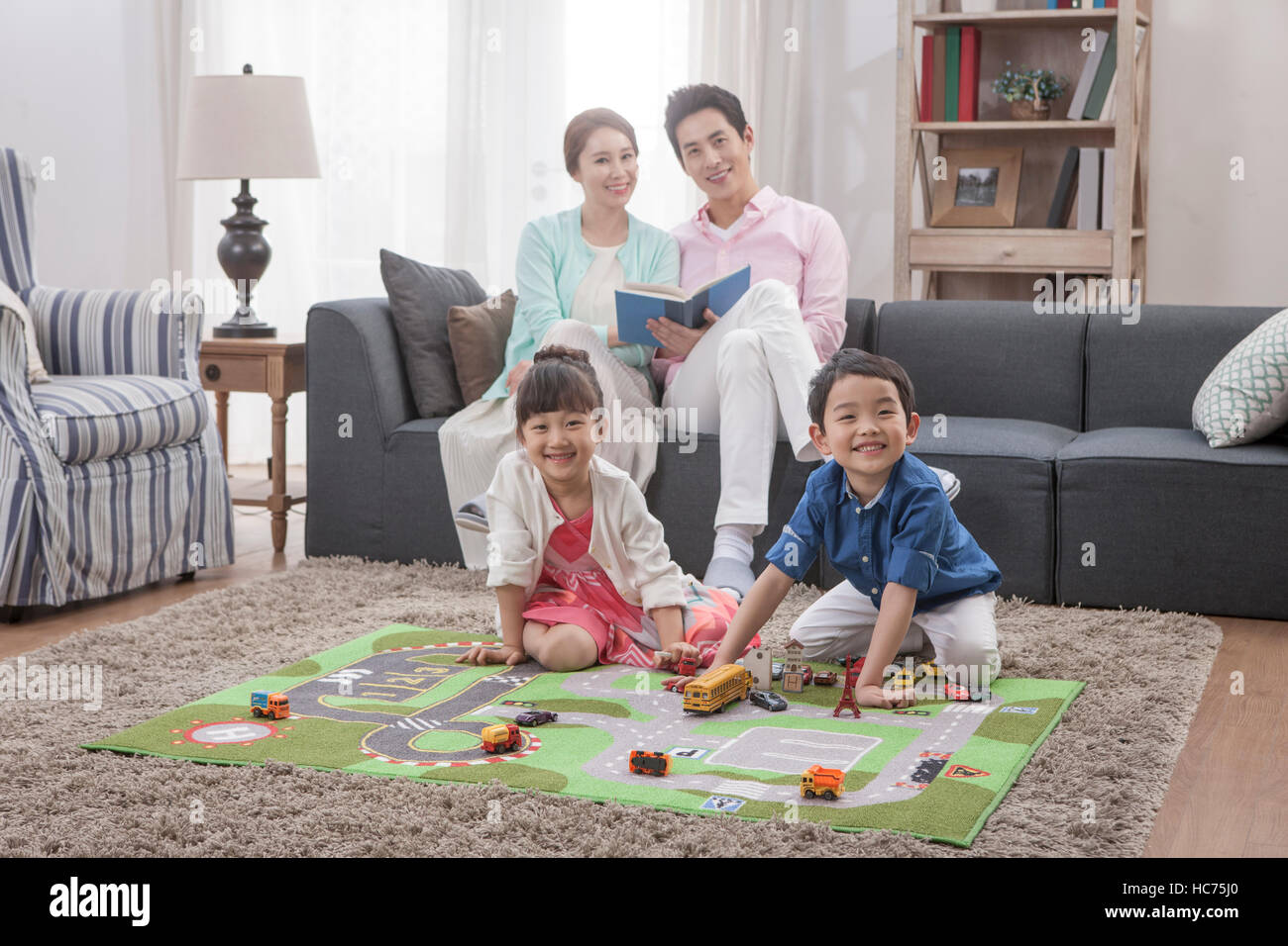 Harmonious family in living room Stock Photo - Alamy