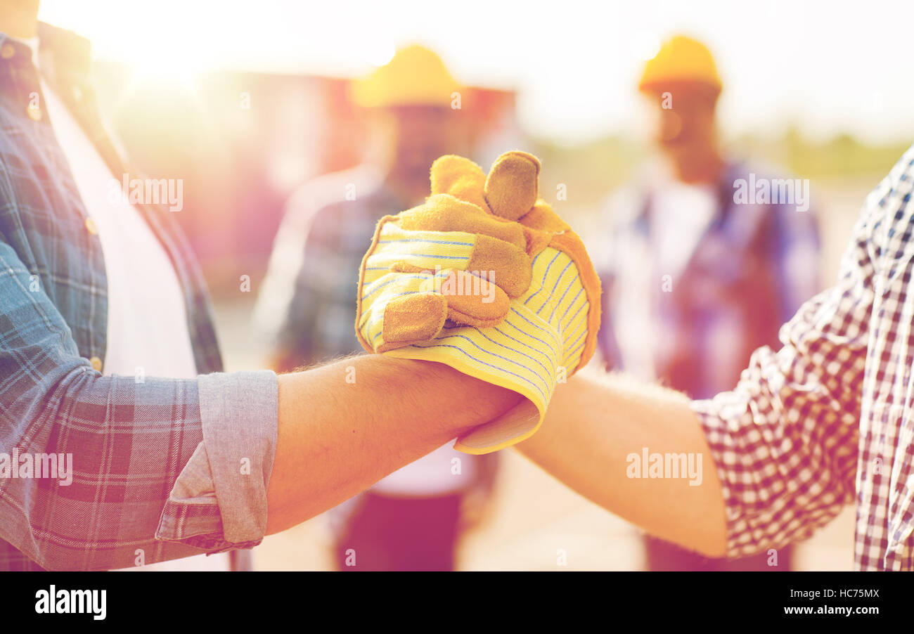 close up of builders hands making handshake Stock Photo - Alamy