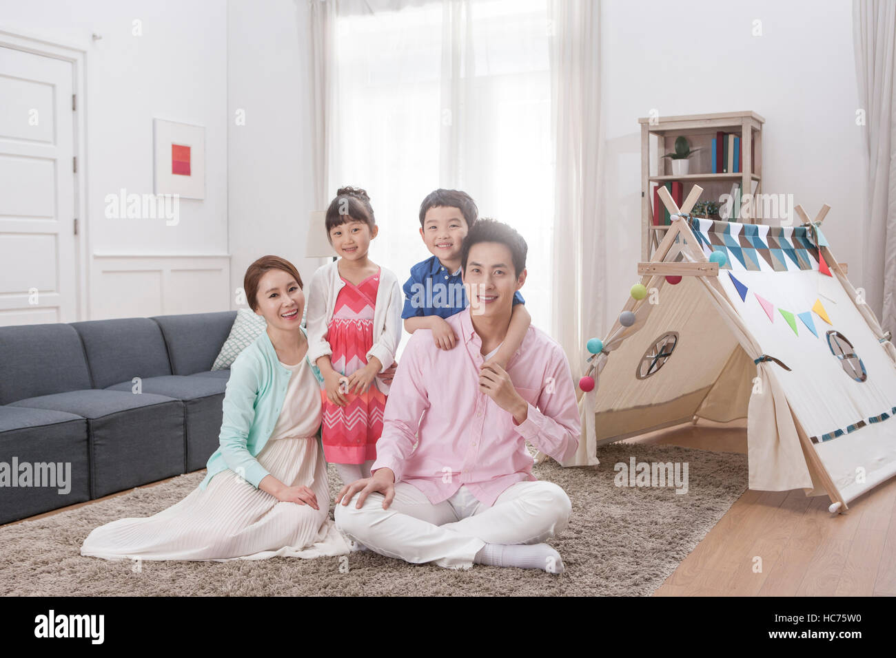 Harmonious family in living room Stock Photo - Alamy