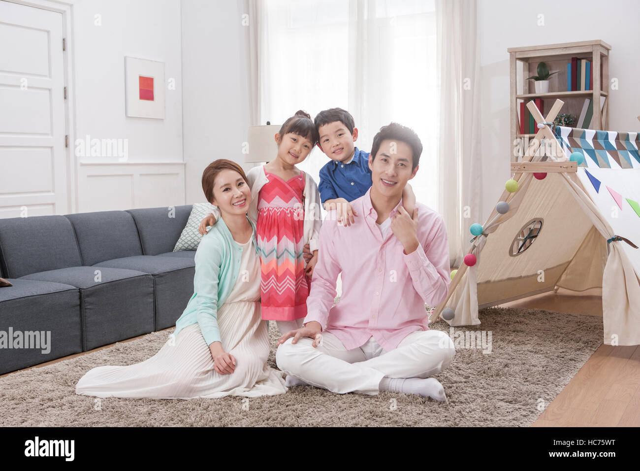 Harmonious family in living room Stock Photo - Alamy